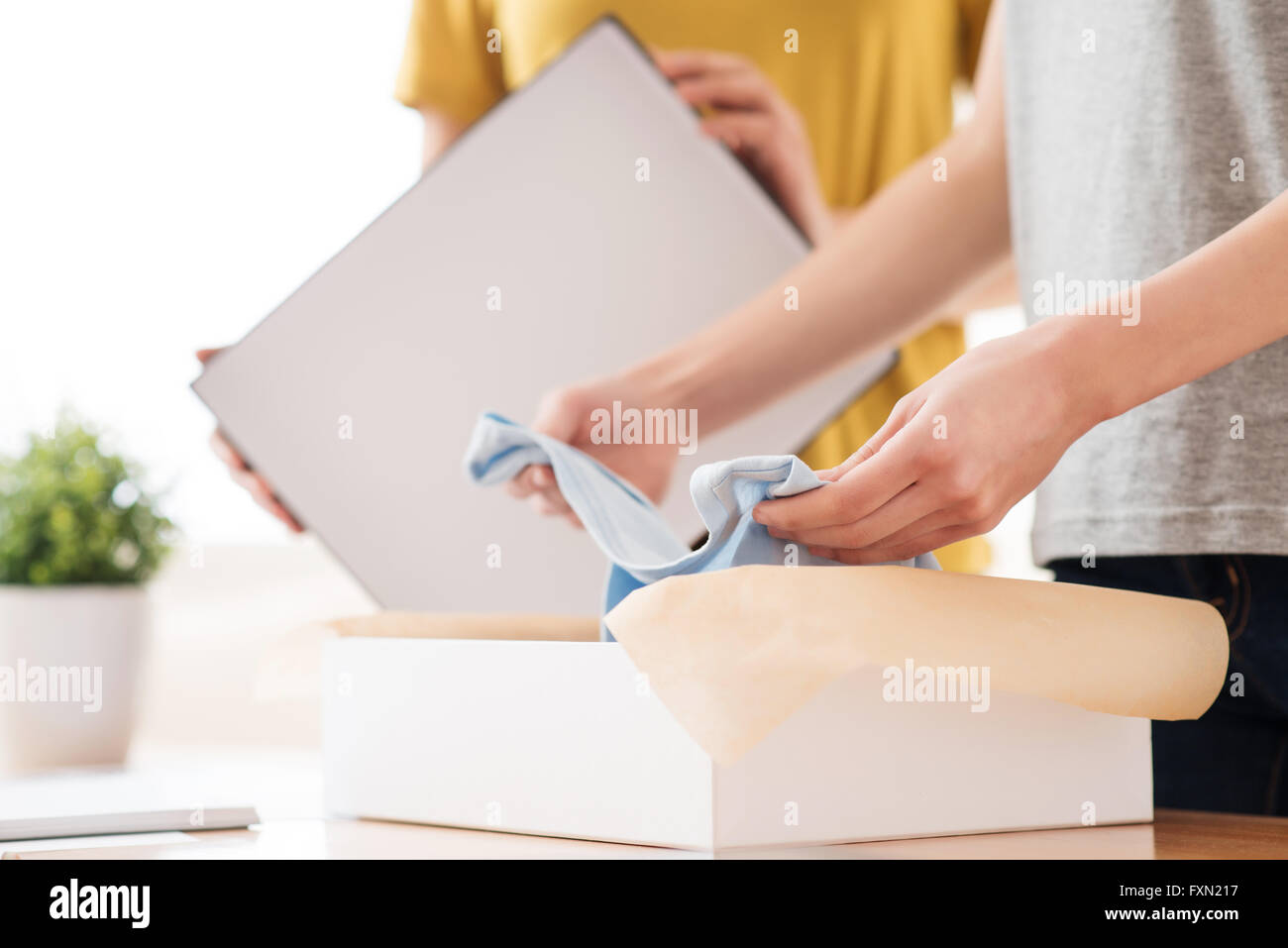 Nice girl opening box Stock Photo - Alamy