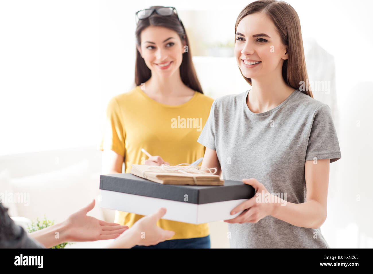 Nice girl giving the box Stock Photo - Alamy