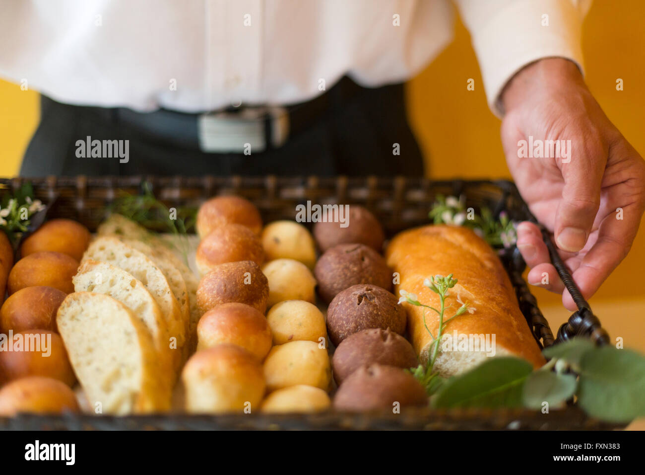 waiter holding basket of breads at French fine dining restaurant Stock ...