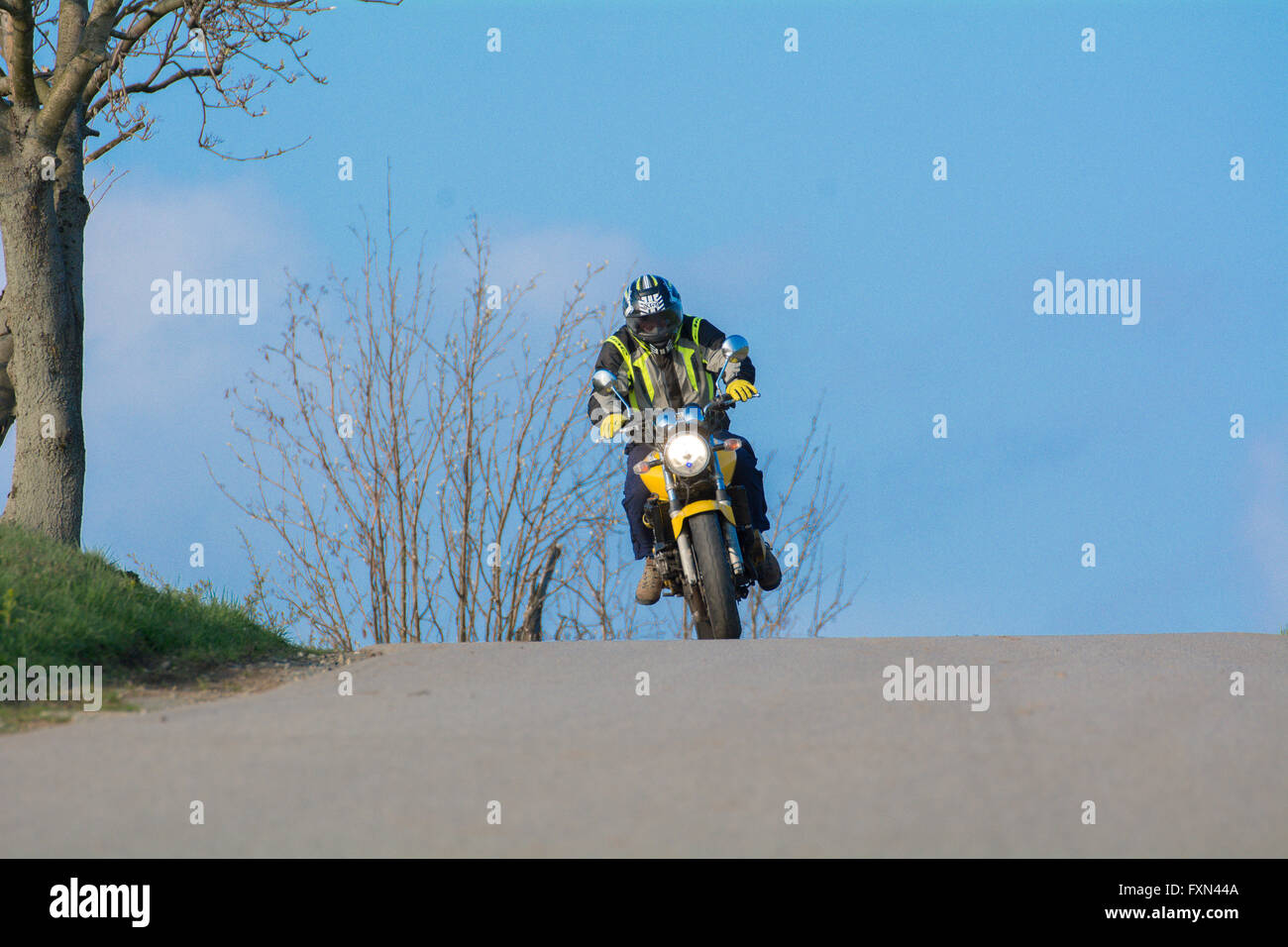 A view of a young man riding a motorcycle on an open road Stock Photo ...