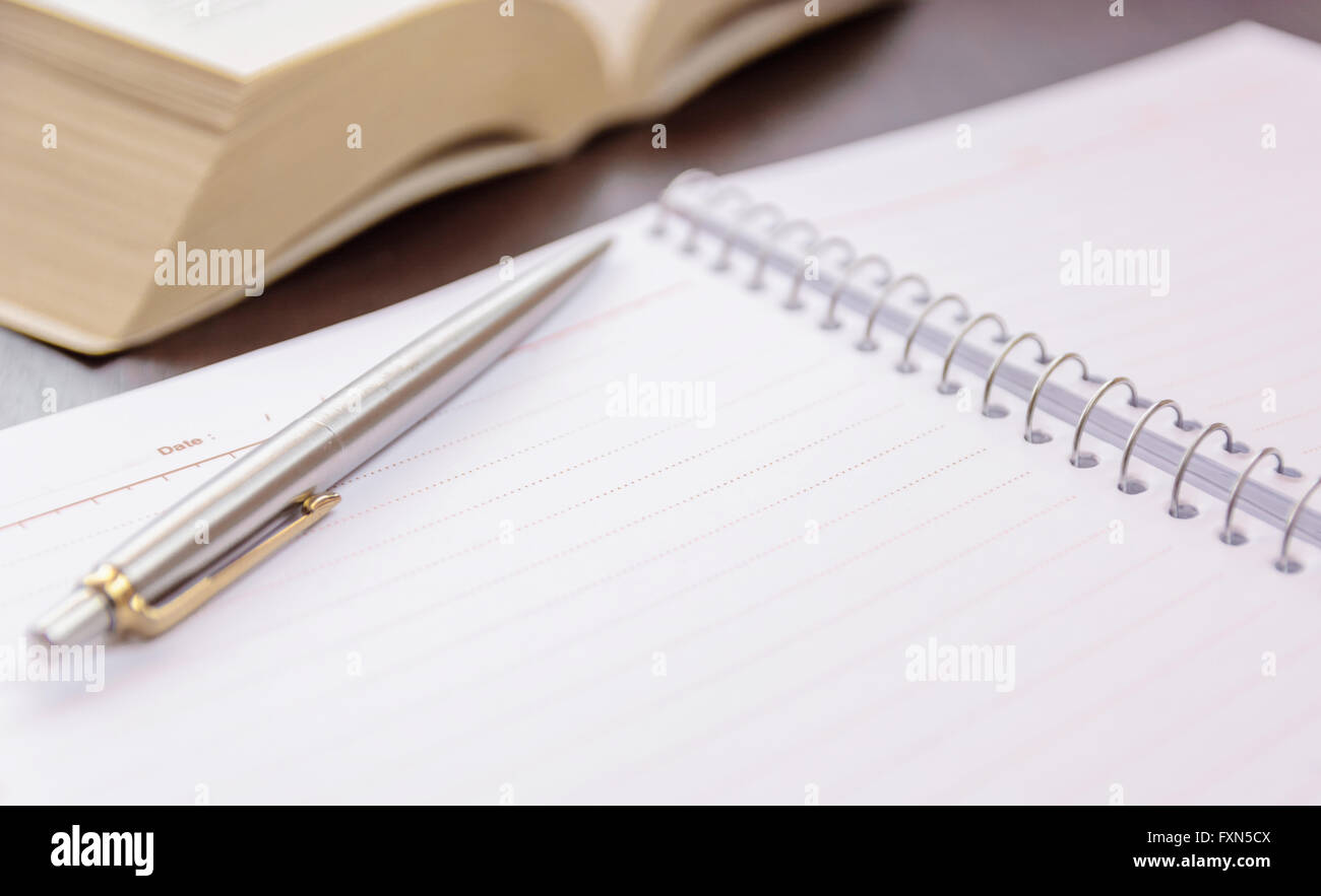 Close-up of open book and pen Stock Photo - Alamy