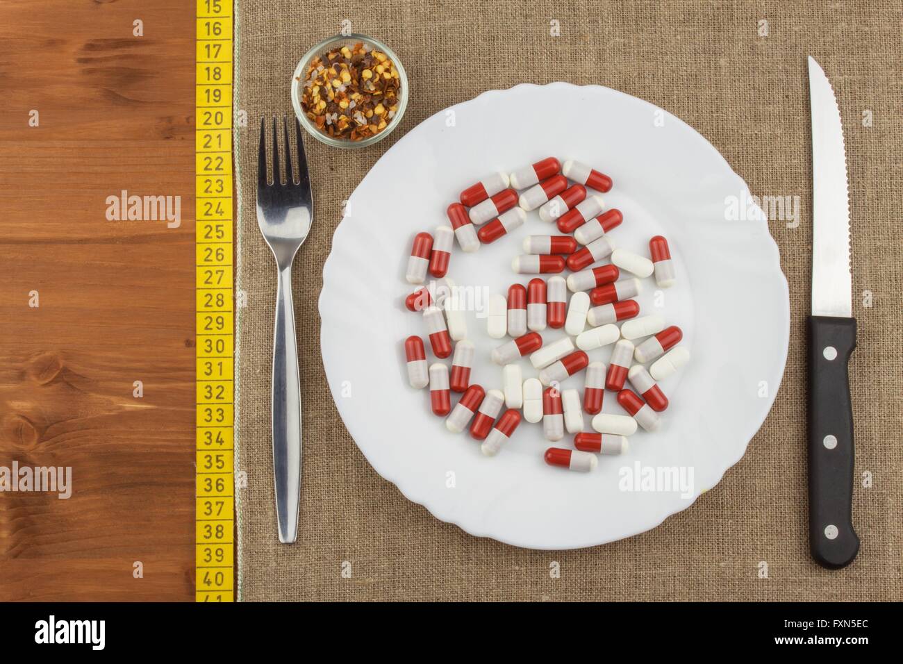 A plate of food supplements and cutlery. Diet food. Strict diet for ...
