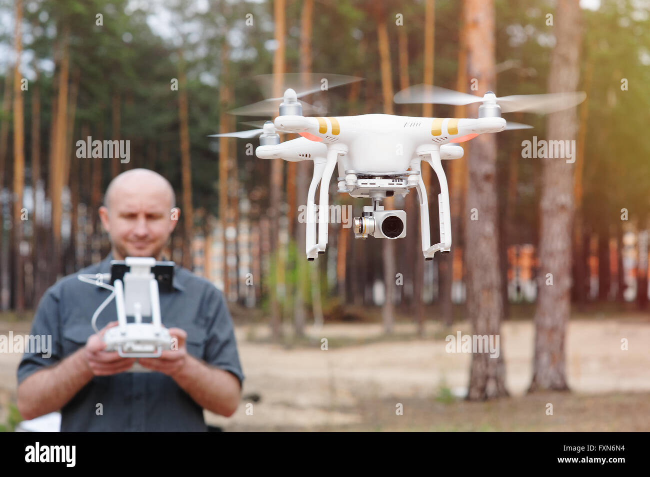 Man using his drone outdoor with forest background Stock Photo - Alamy