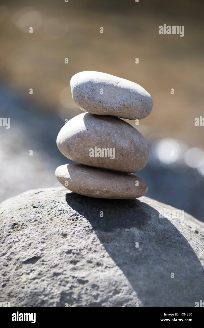 meditation stones sitting on boulder by stream Stock Photo - Alamy
