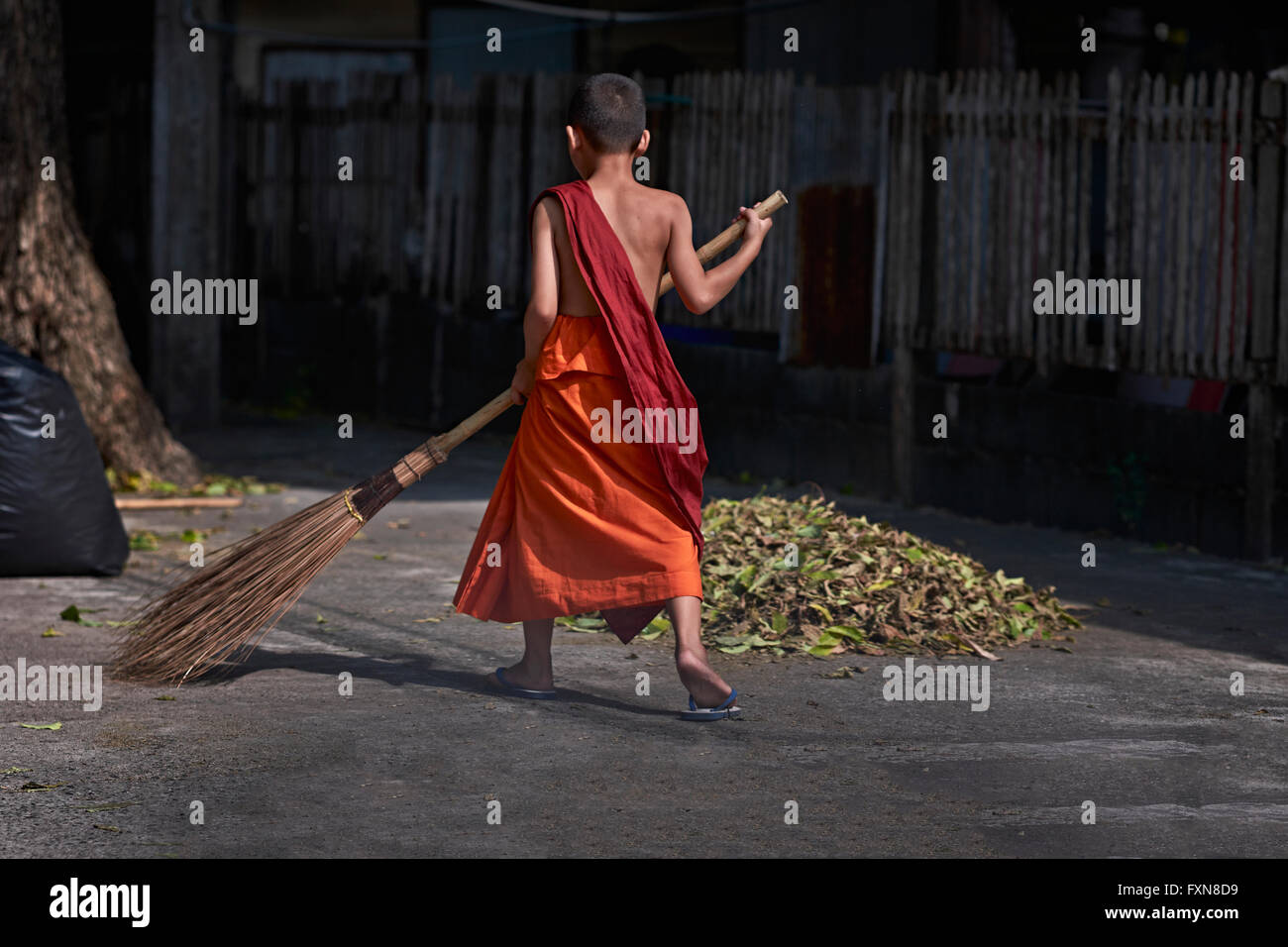 Young buddhist monk sweeping hi-res stock photography and images - Alamy