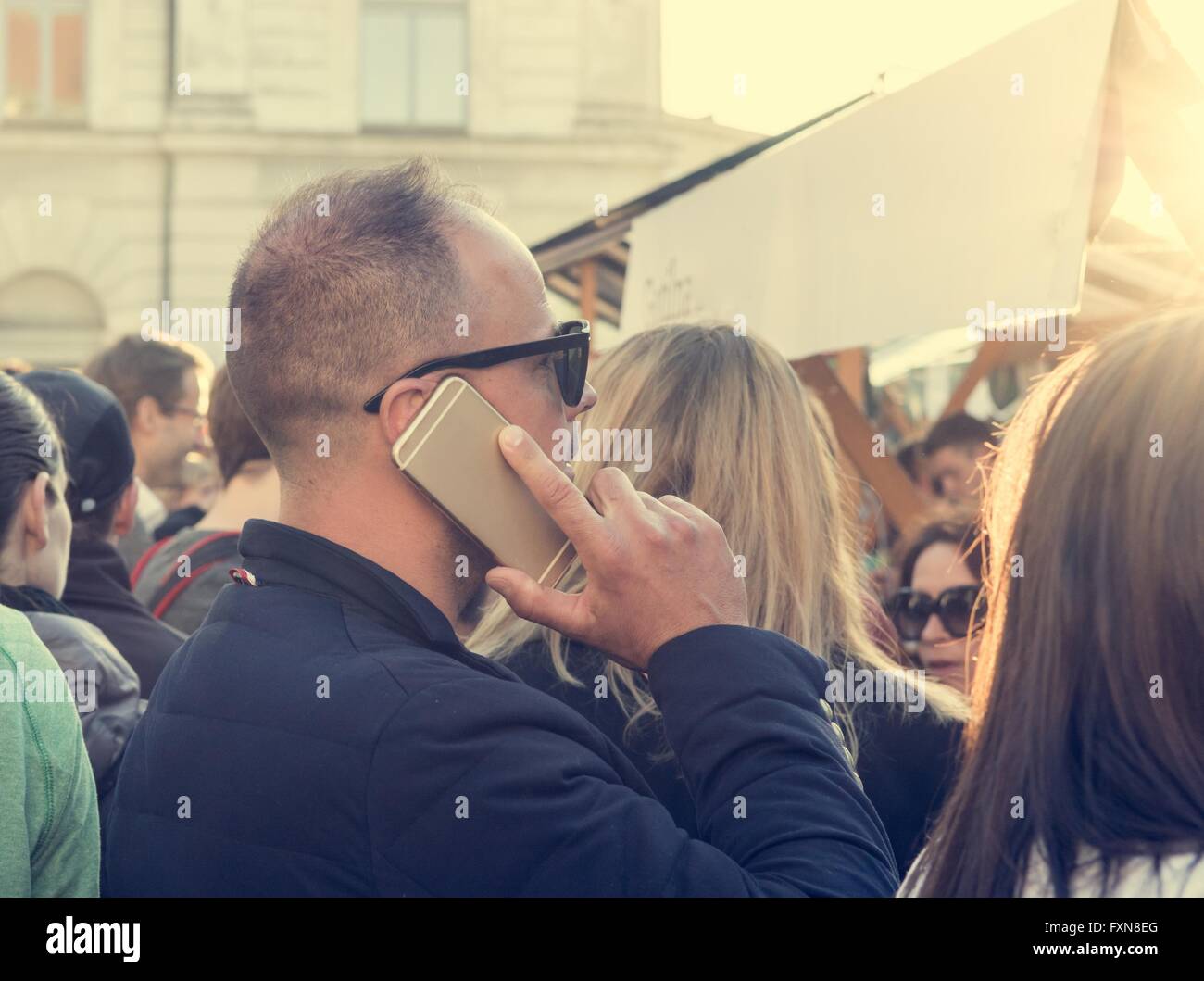Man talking on a cell phone in the crowd Stock Photo - Alamy