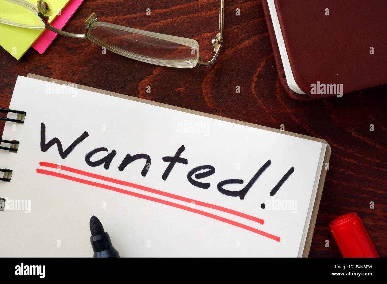 Wanted written in a notebook. Motivation concept Stock Photo - Alamy