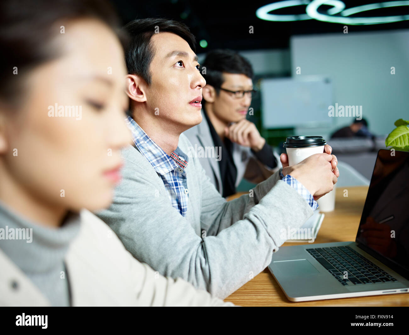 asian businessman looking up and thinking during meeting Stock Photo ...
