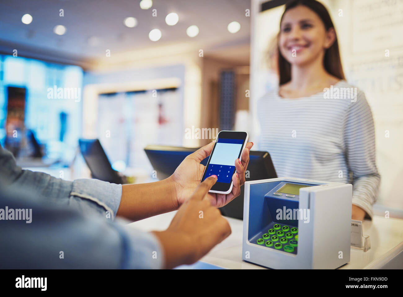 Close up view on fingers of customer entering information on phone in ...