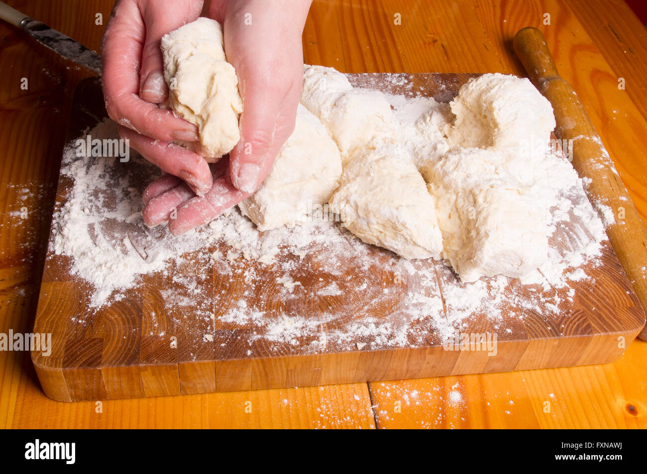 Making dough by female hands on wooden table background Stock Photo - Alamy