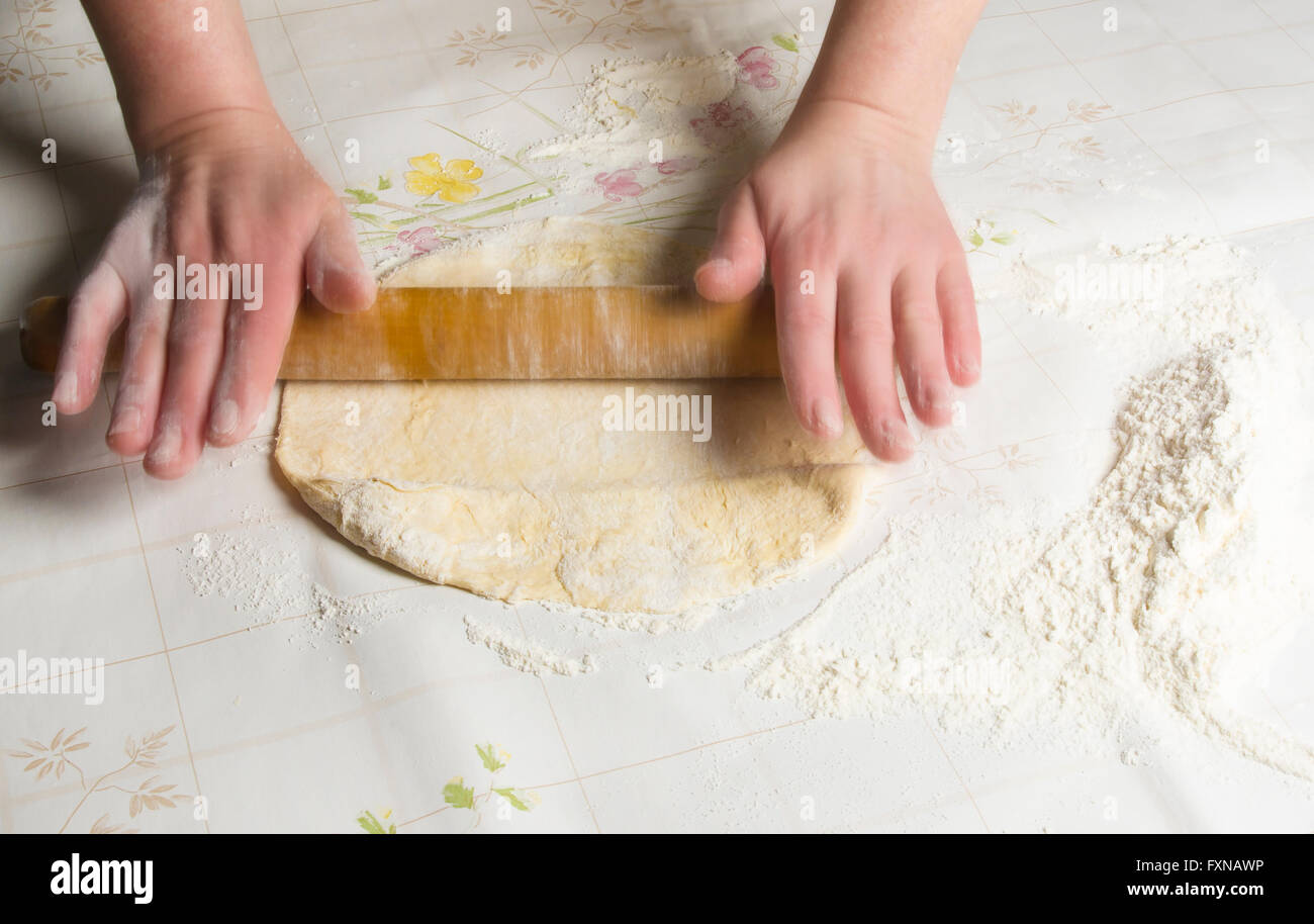 Making dough by female hands on wooden table background Stock Photo - Alamy