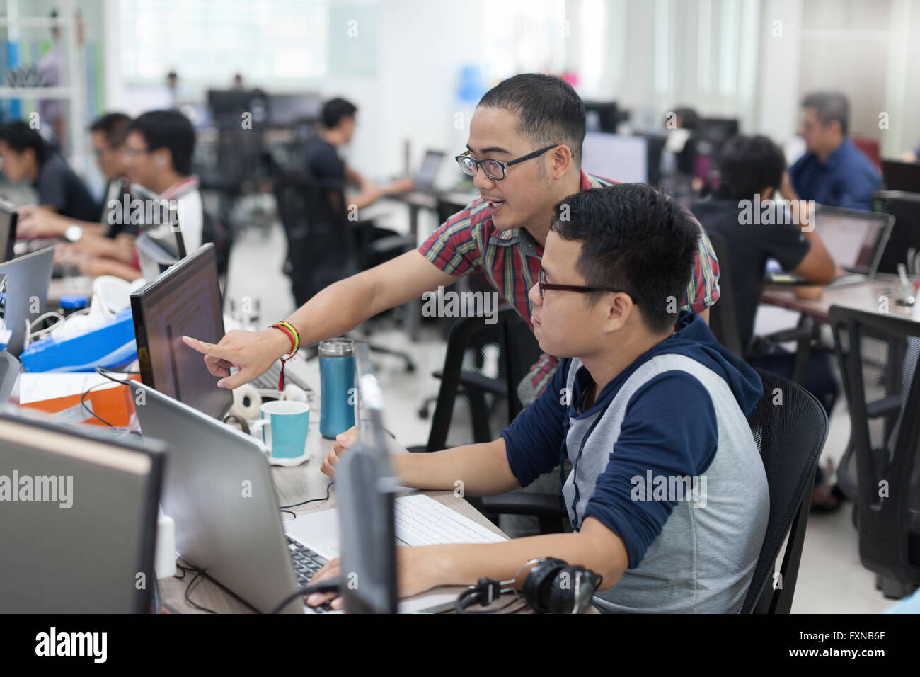 Asian Colleagues Software Developers Team Sitting At Desk Working Stock ...