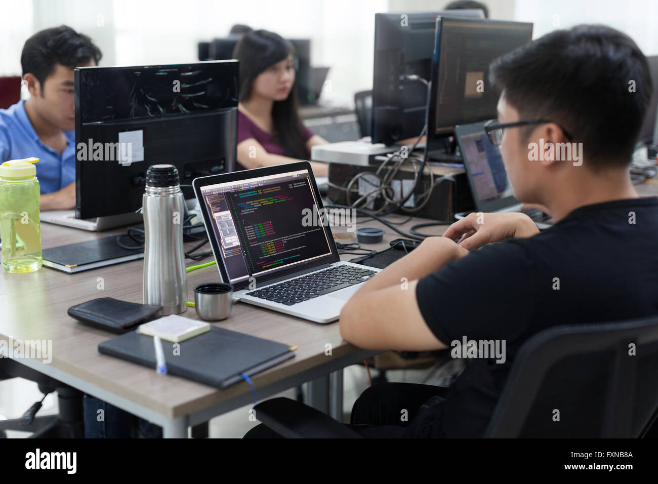Asian woman sitting desk coding hi-res stock photography and images - Alamy