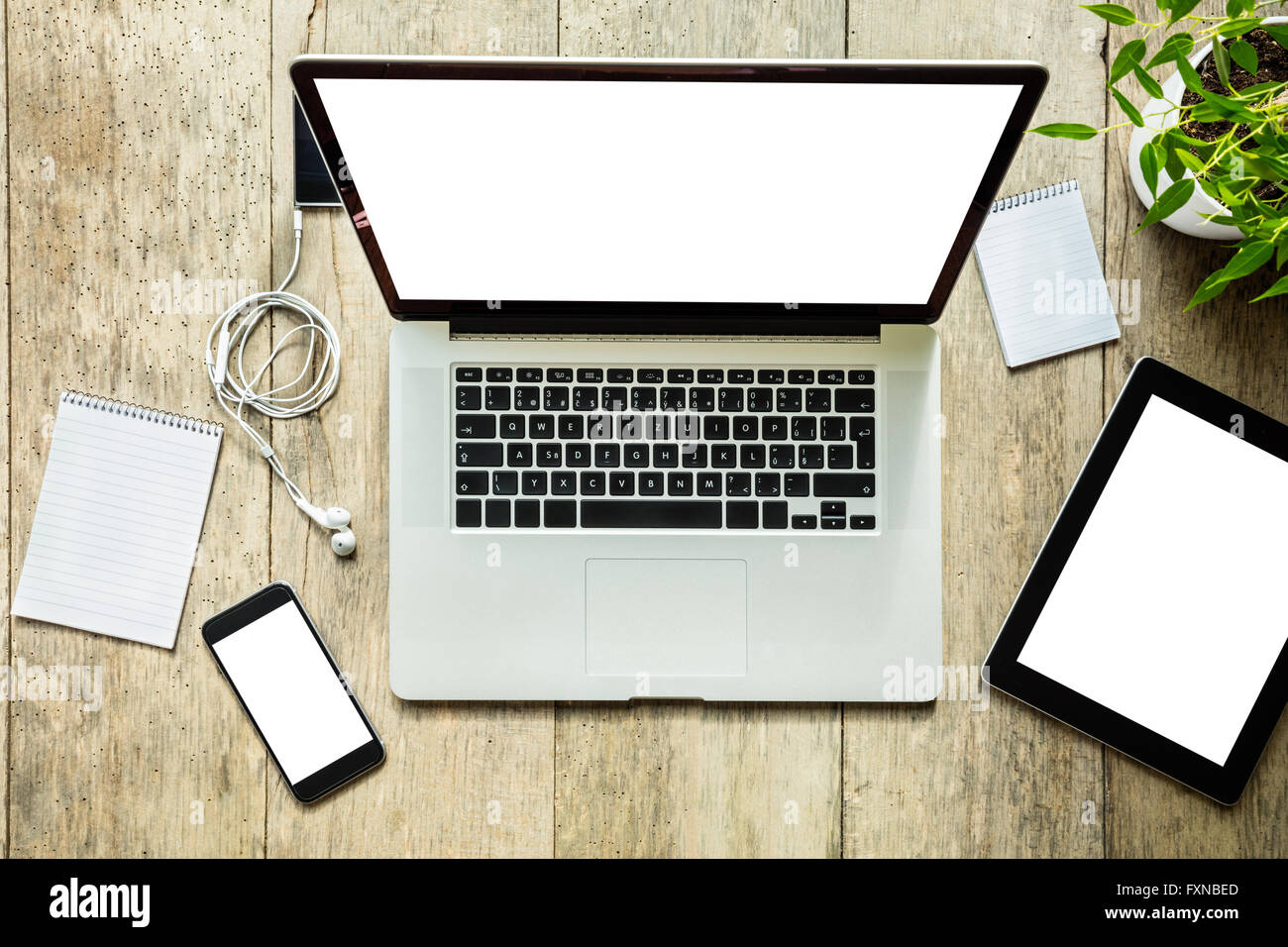 Laptop with other modern electonic devices on desk Stock Photo - Alamy