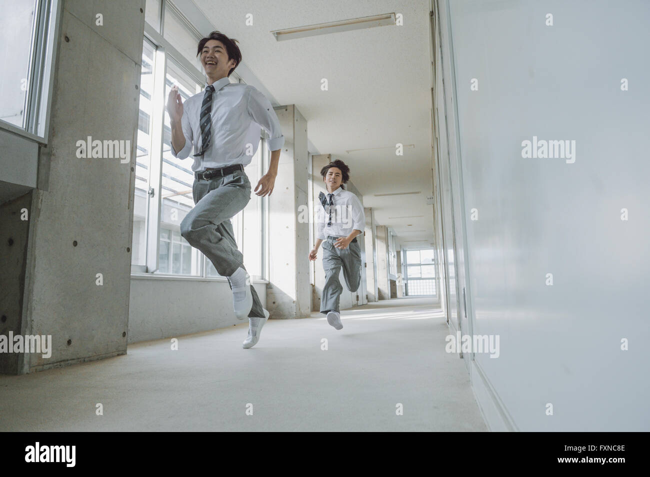 Japanese high-school students running in school corridor Stock Photo ...