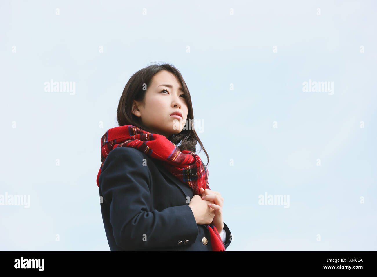 Japanese high-school student with scarf against blue sky Stock Photo ...