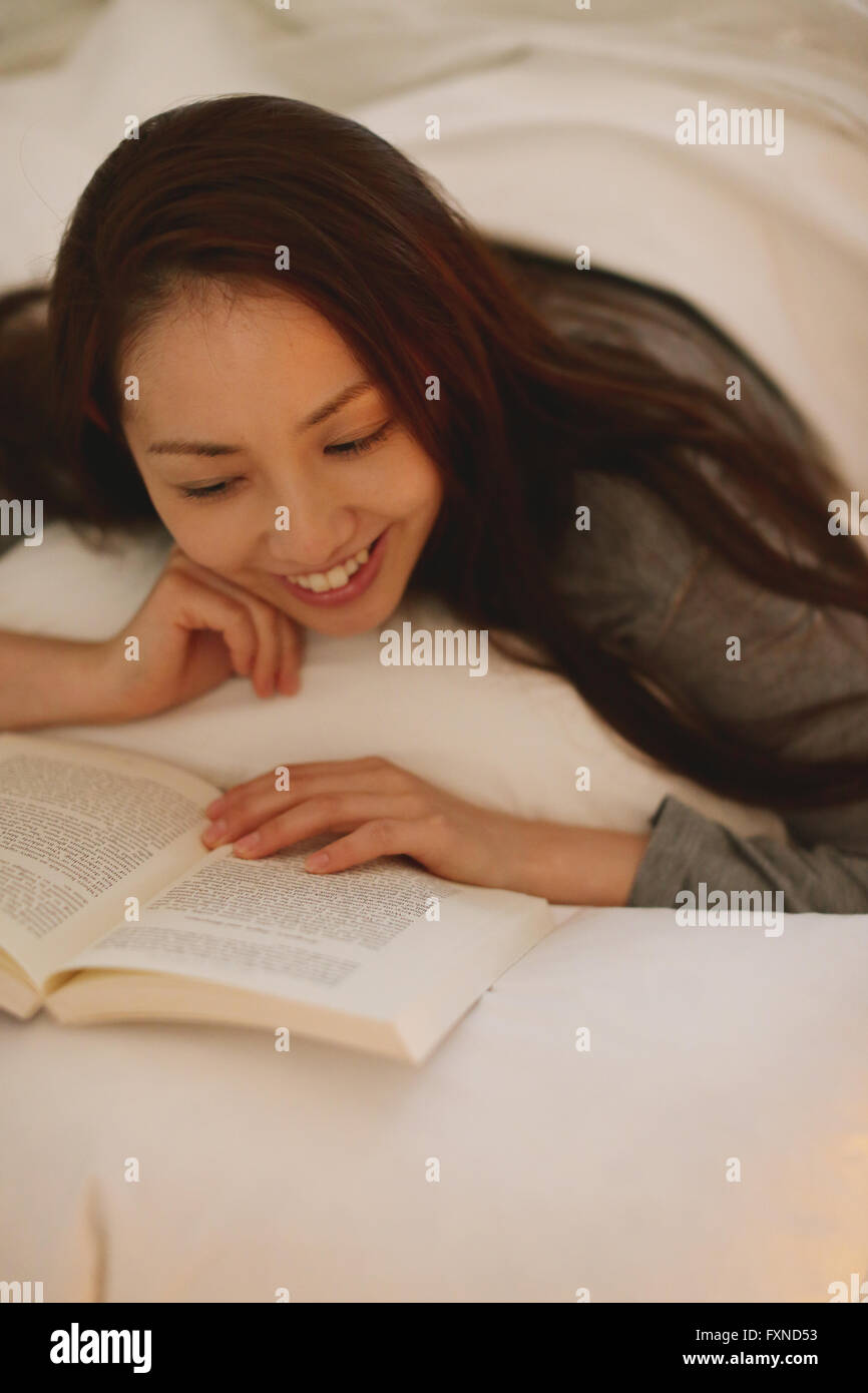 Young attractive Japanese woman reading in bed Stock Photo - Alamy