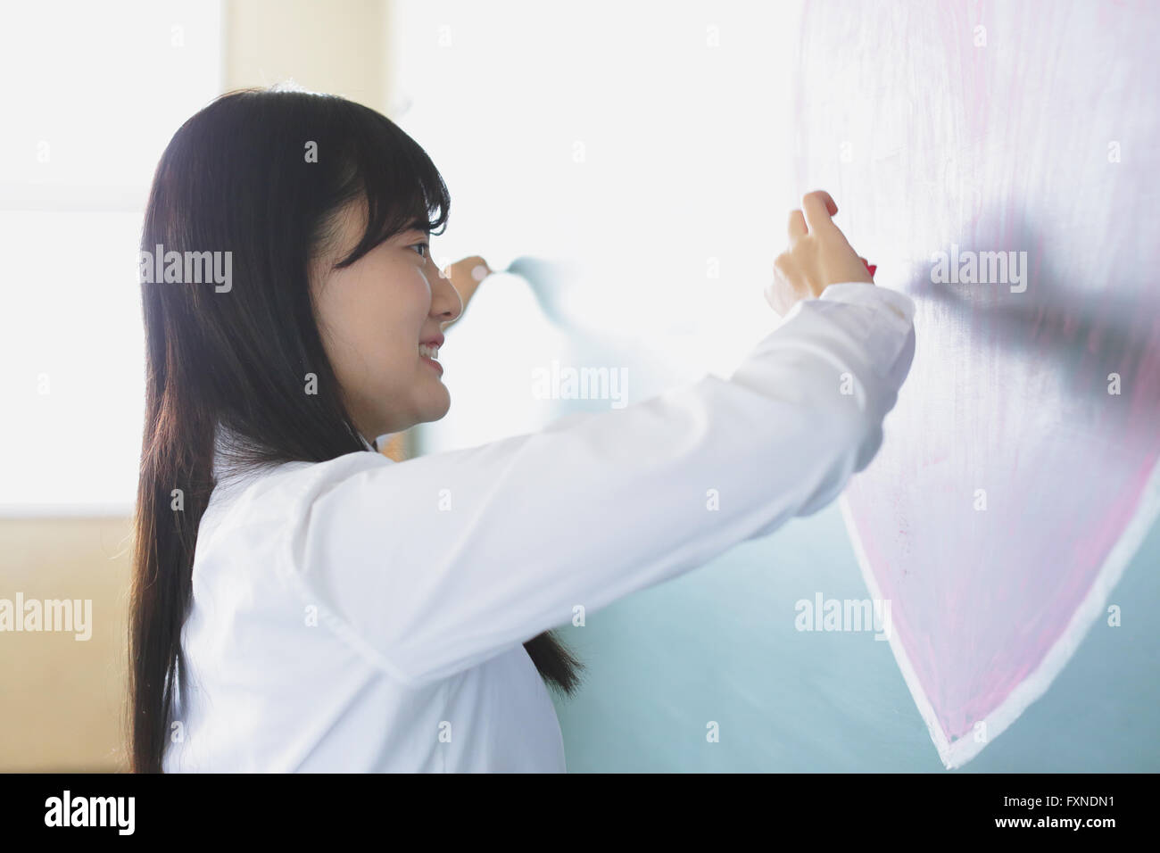 Japanese high-school student writing on classroom blackboard Stock ...