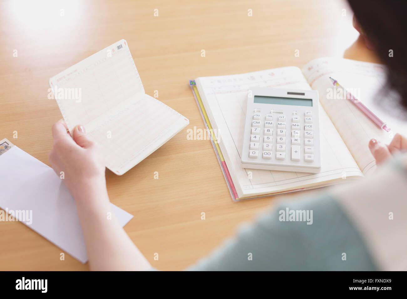 Senior Japanese woman doing accounting in the living room Stock Photo ...