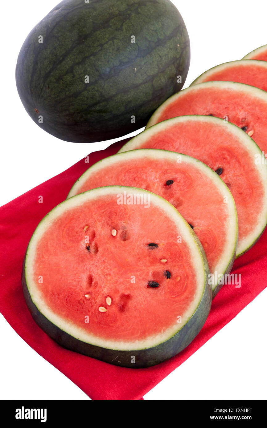 The watermelon and cut into split on a red cloth Stock Photo - Alamy