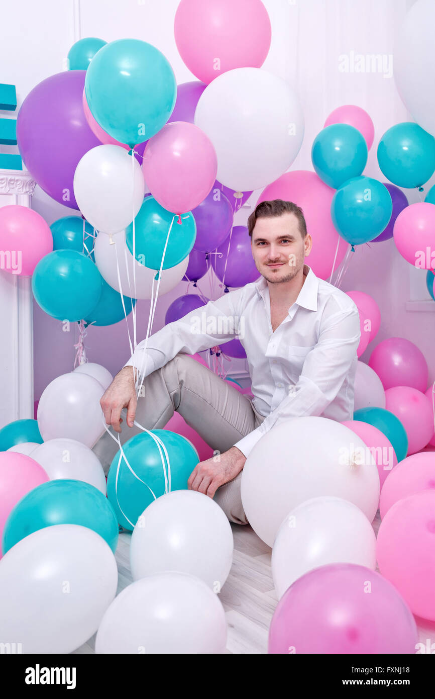 Young romantic man in white shirt. Men's fashion. Man sitting on the ...