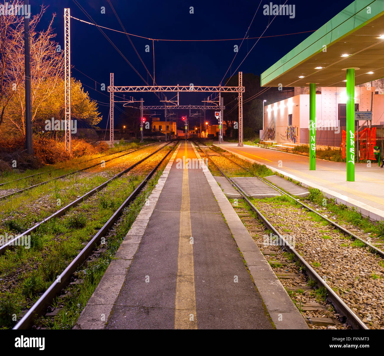 closed evening train station, rails and red light Stock Photo - Alamy