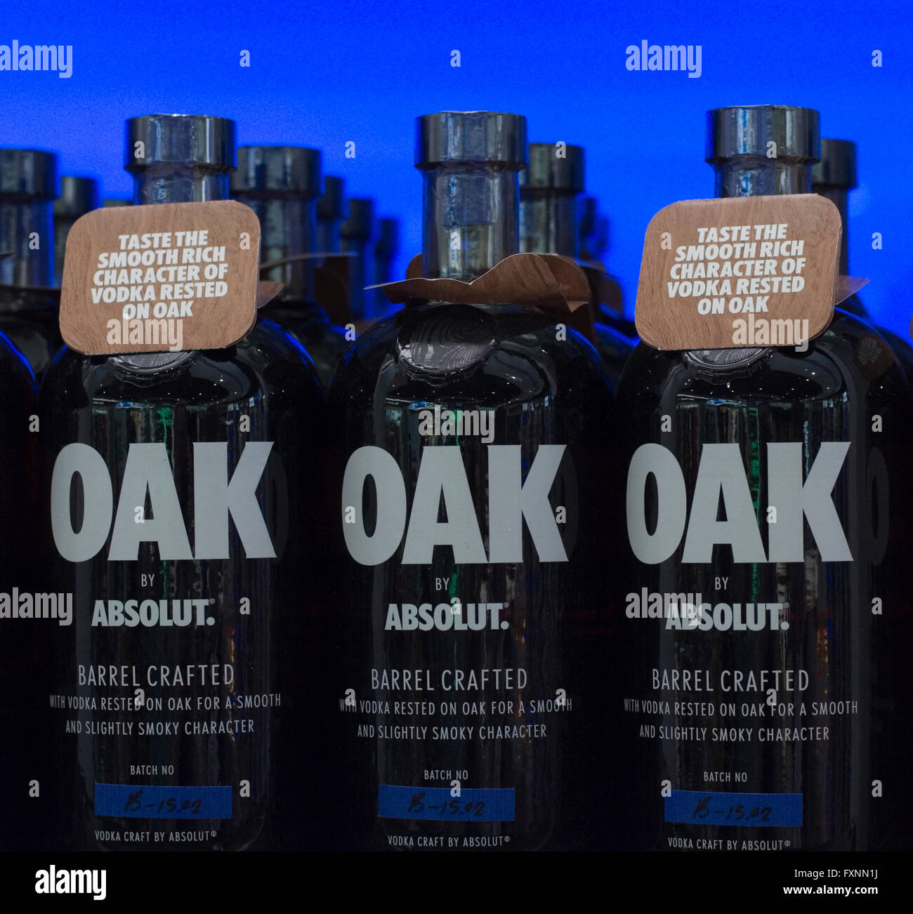 Absolut Vodka Oak. Bottles on display against a blue illuminated ...