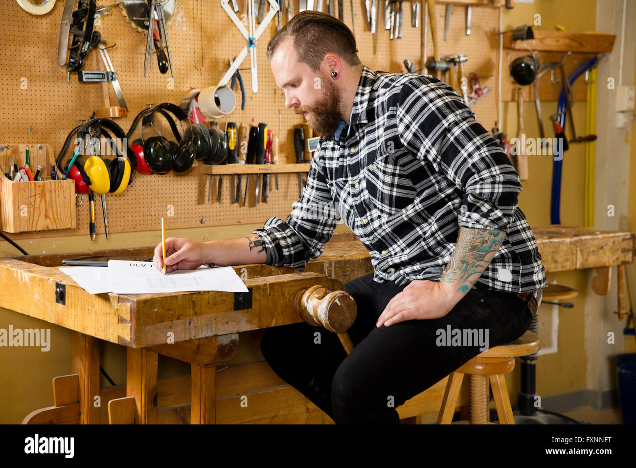 Carpenter planning new work in the workshop Stock Photo - Alamy