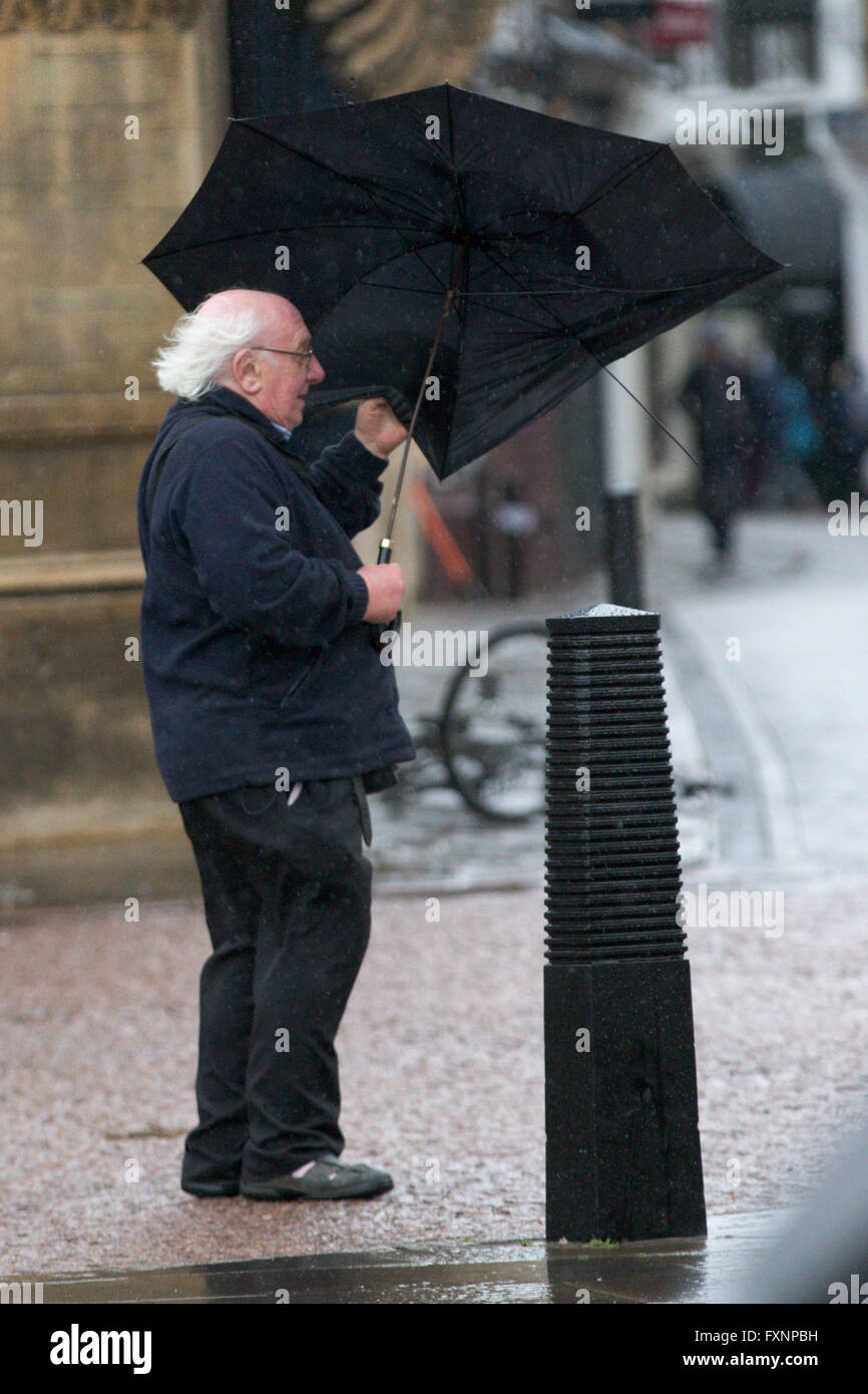 Tourists Cambridge under umbrellas in bad weather whilst walking and ...
