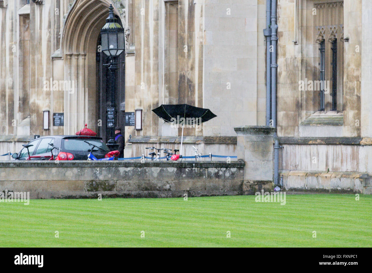 Tourists Cambridge under umbrellas in bad weather whilst walking and ...