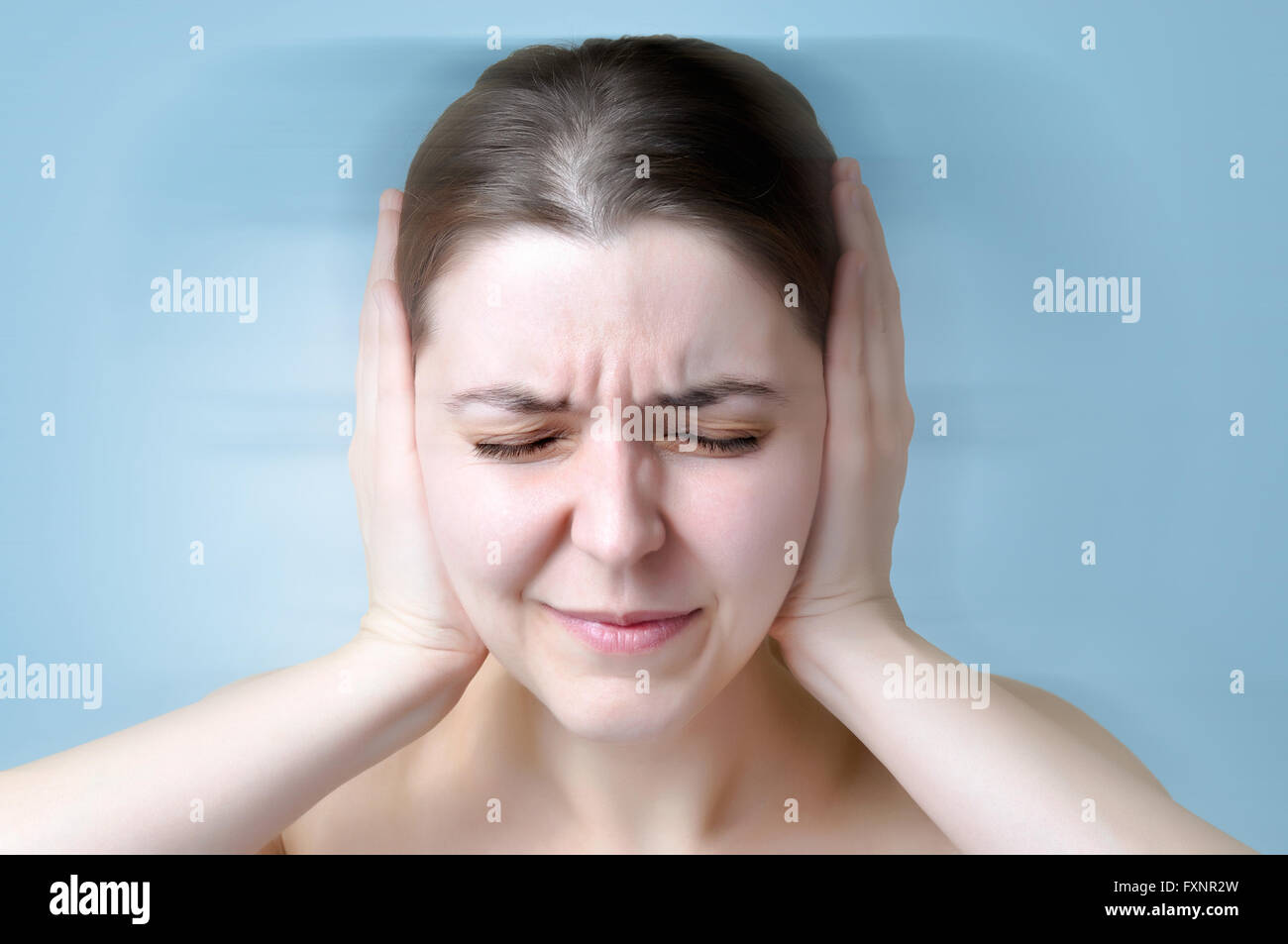 Young woman covering her ears Stock Photo - Alamy