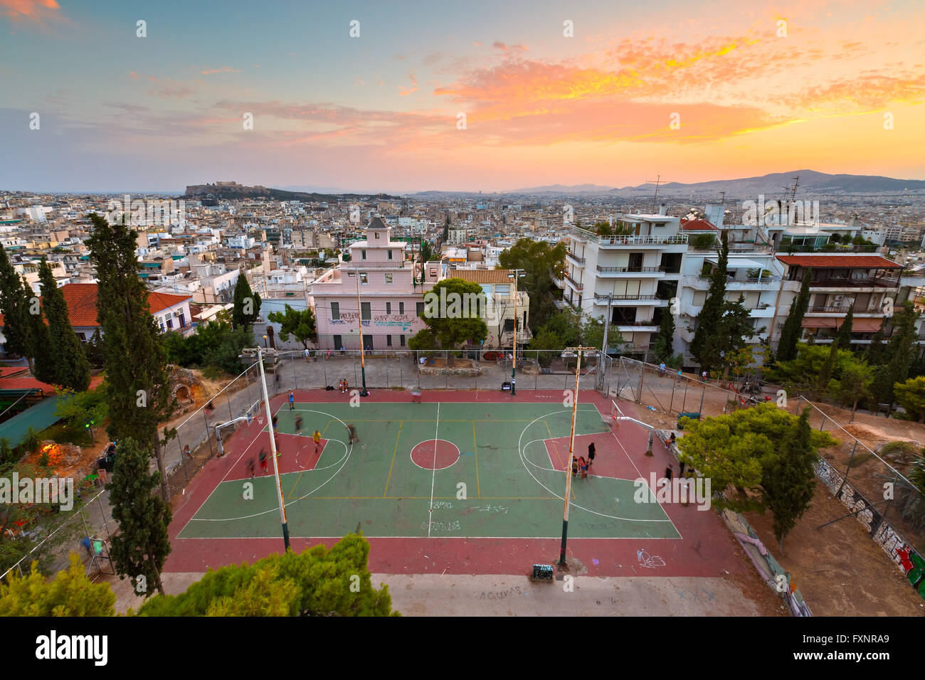 View of Athens and Acropolis from Strefi Hill. Basketball playground in ...