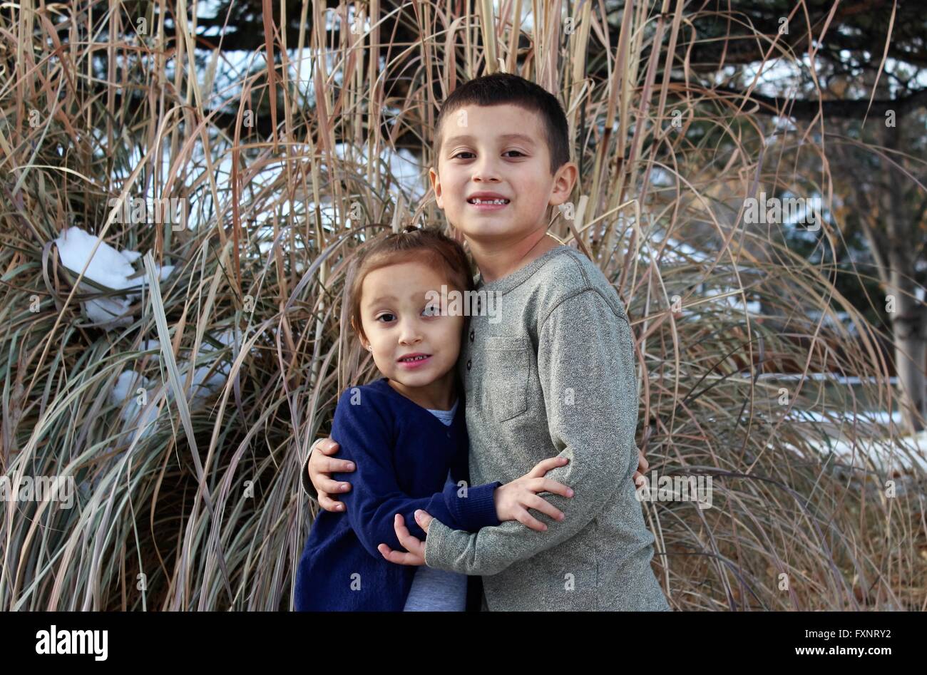 Children hugging outside Stock Photo - Alamy