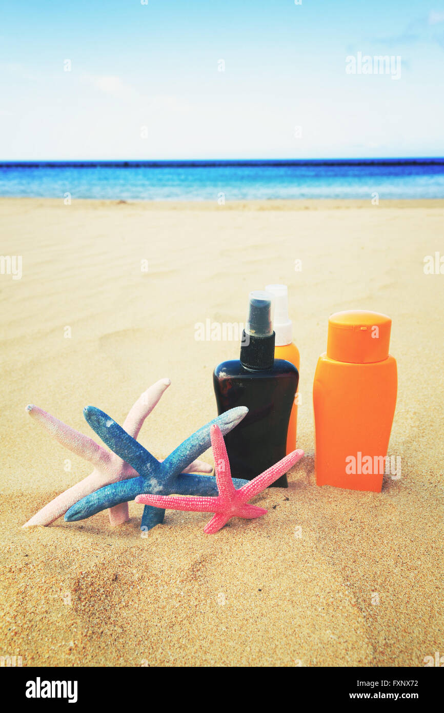 suntun creams on sandy beach Stock Photo - Alamy