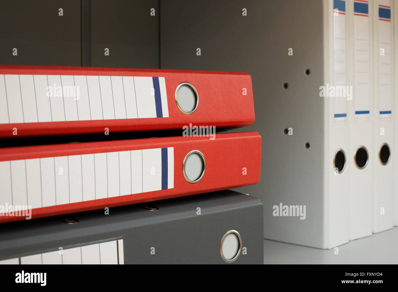 Folders for documents on a book shelf at office Stock Photo - Alamy