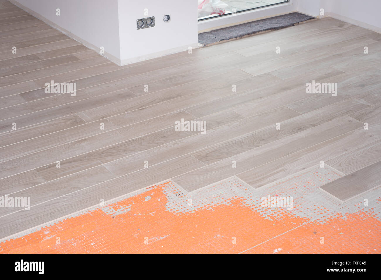 floor renovation with ceramic tiles in wood design Stock Photo - Alamy