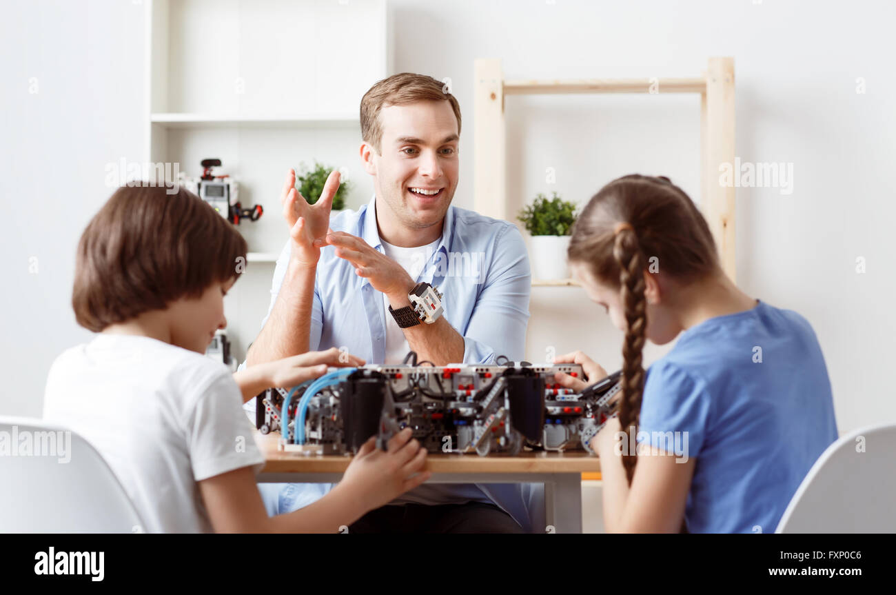 Positive father playing with kids Stock Photo - Alamy