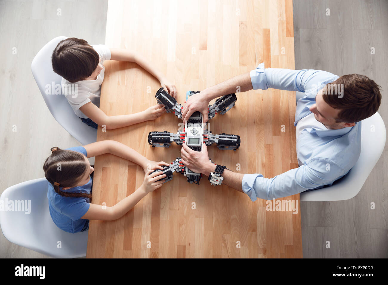 Positive father playing with kids Stock Photo - Alamy
