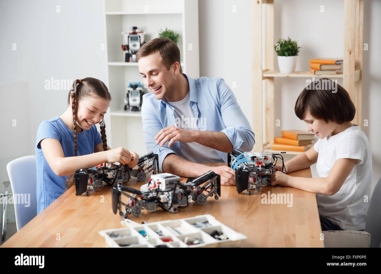 Positive father playing with kids Stock Photo - Alamy