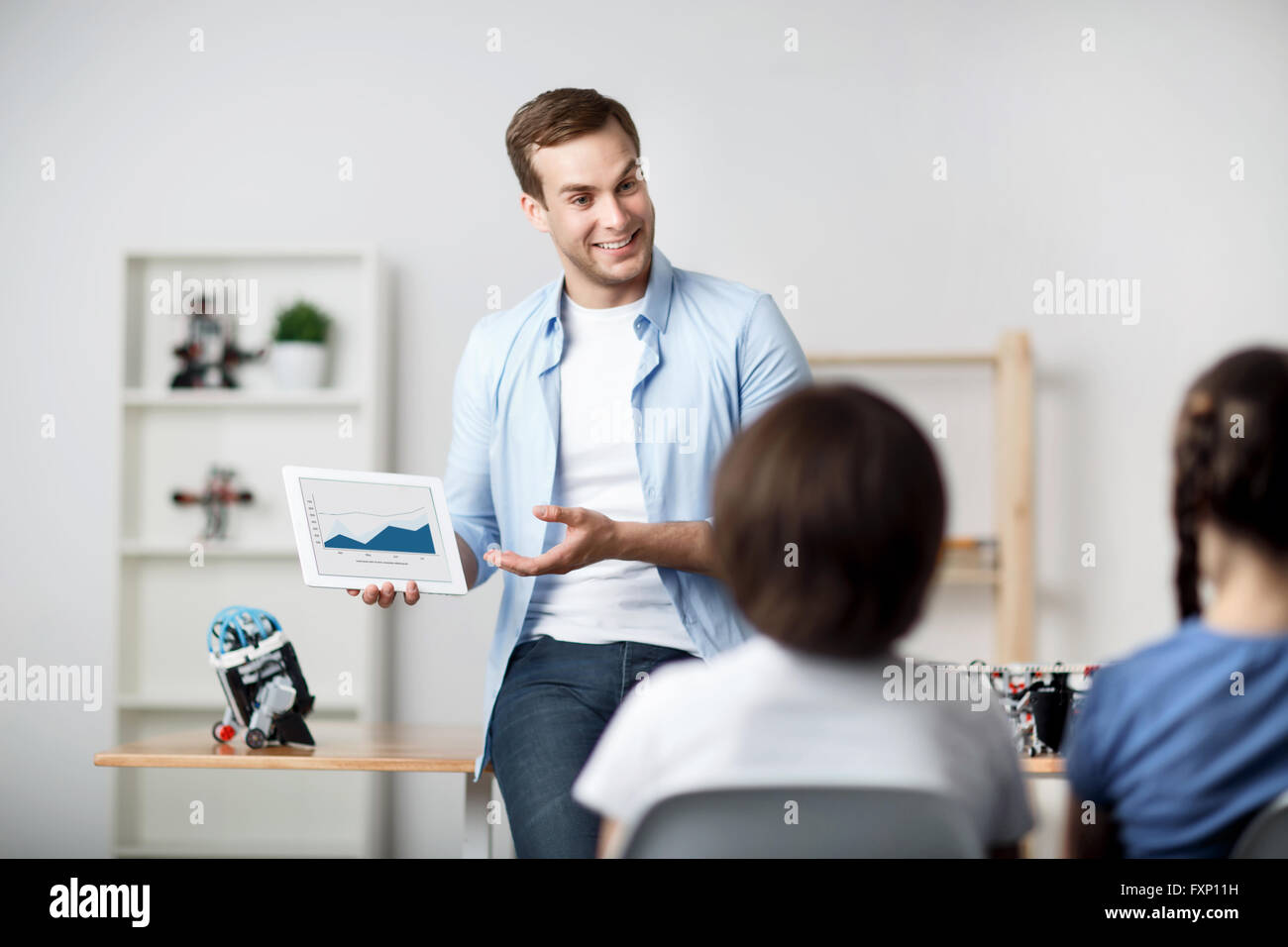 Positive father playing with kids Stock Photo - Alamy