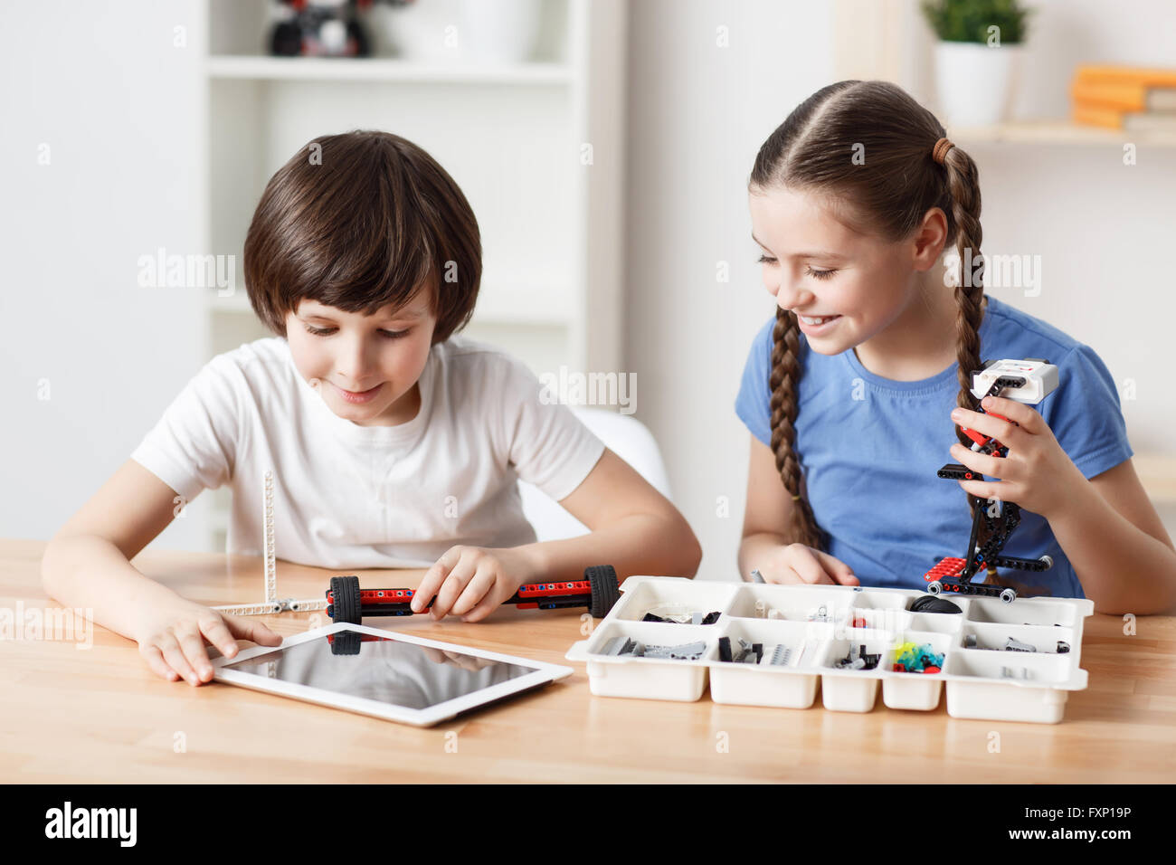 Nice children sitting at the table Stock Photo - Alamy