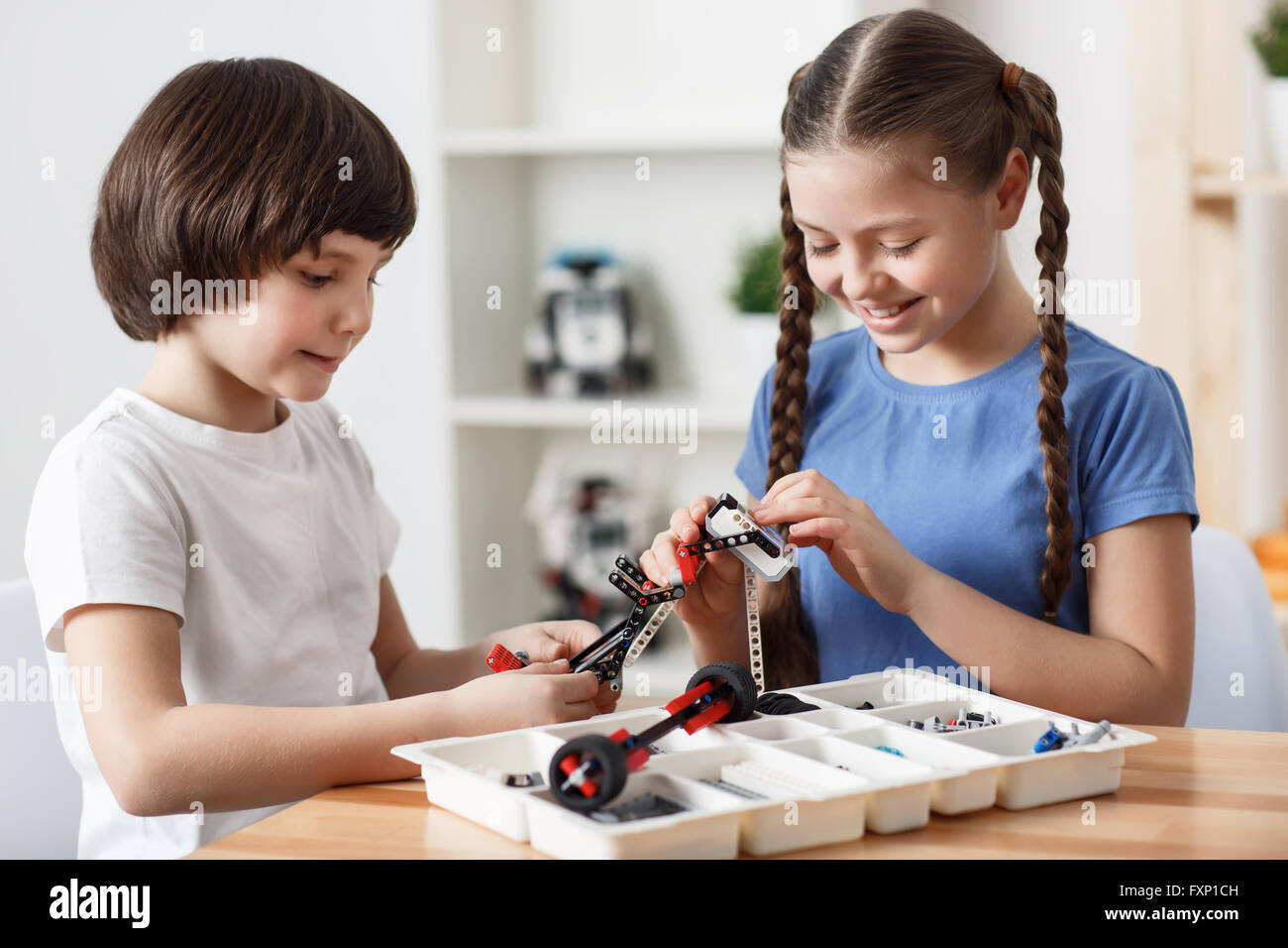 Happy children sitting at the table Stock Photo - Alamy