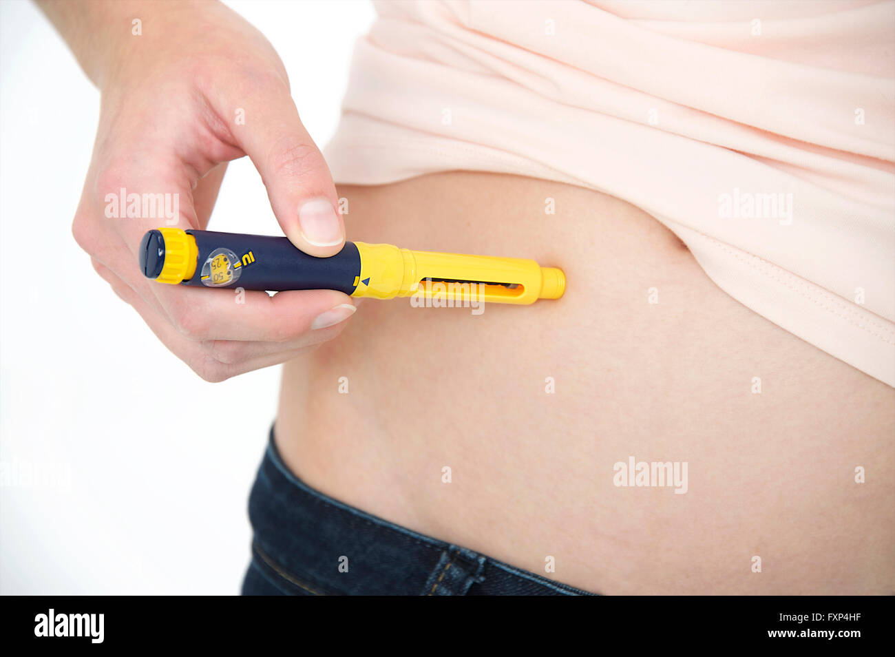 MODEL RELEASED. Woman using a puregon injection to treat infertility ...