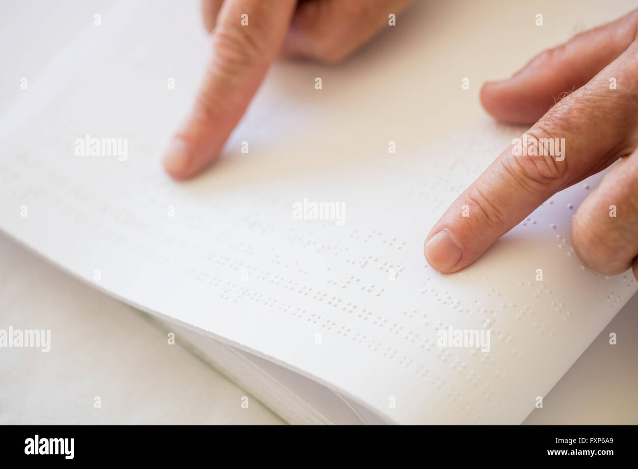 Blind senior woman using braille to read Stock Photo - Alamy