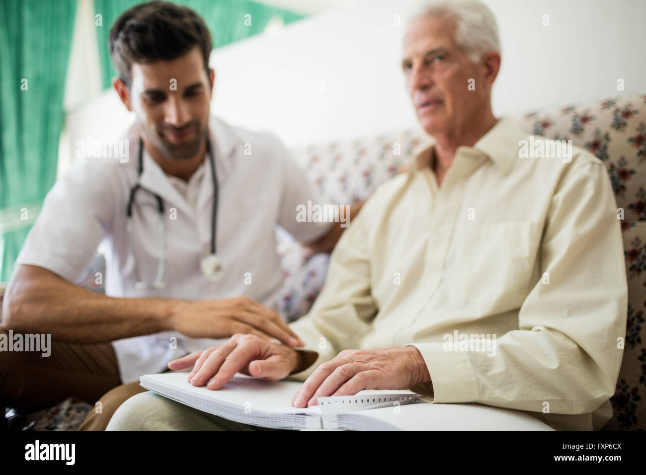 Blind senior man using braille to read Stock Photo - Alamy