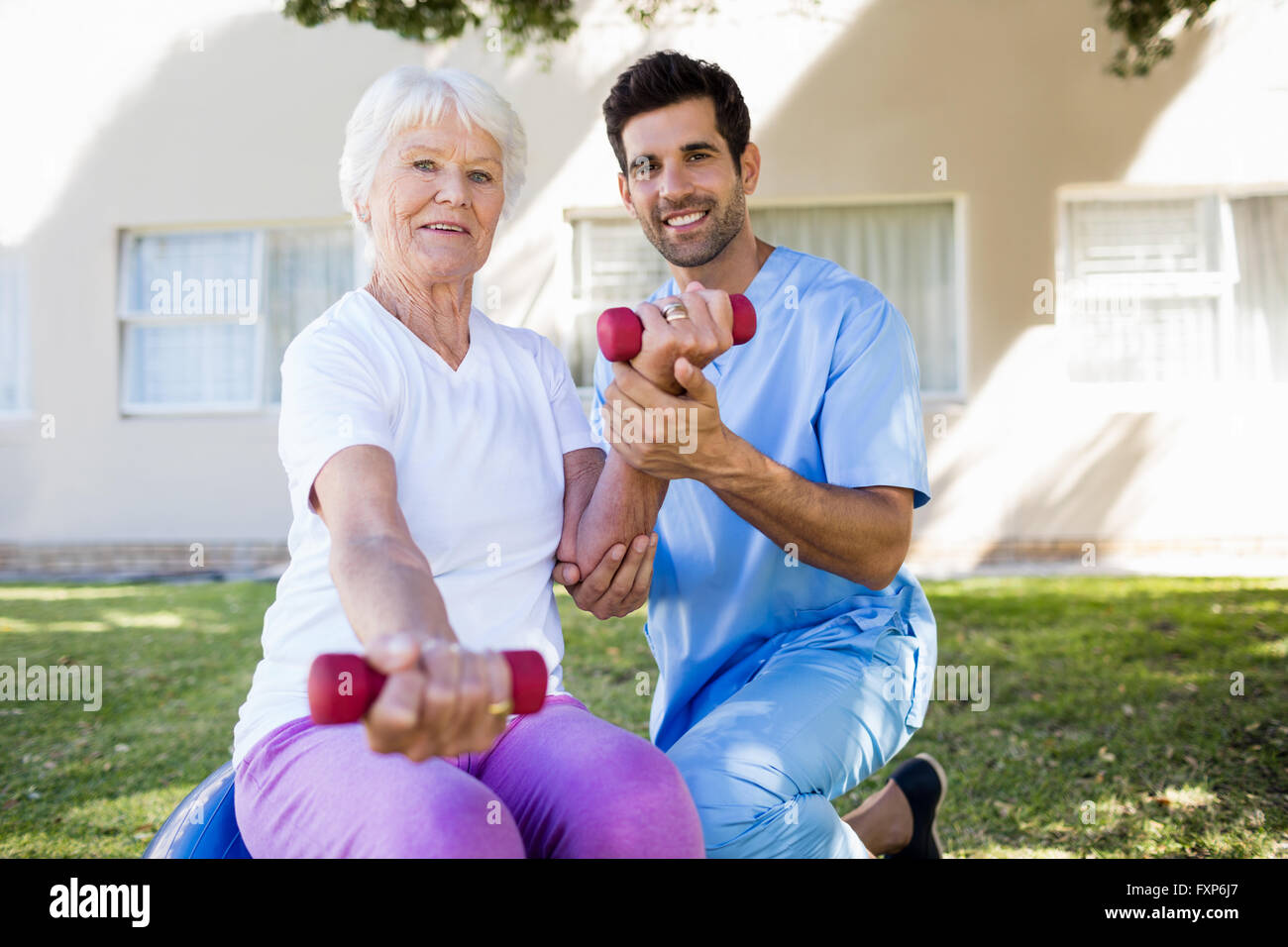 Nurse helping senior woman doing exercises Stock Photo - Alamy