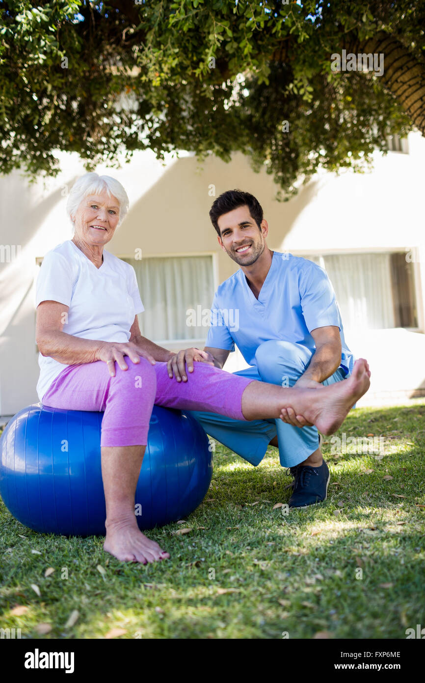 Nurse helping senior woman doing exercises Stock Photo - Alamy