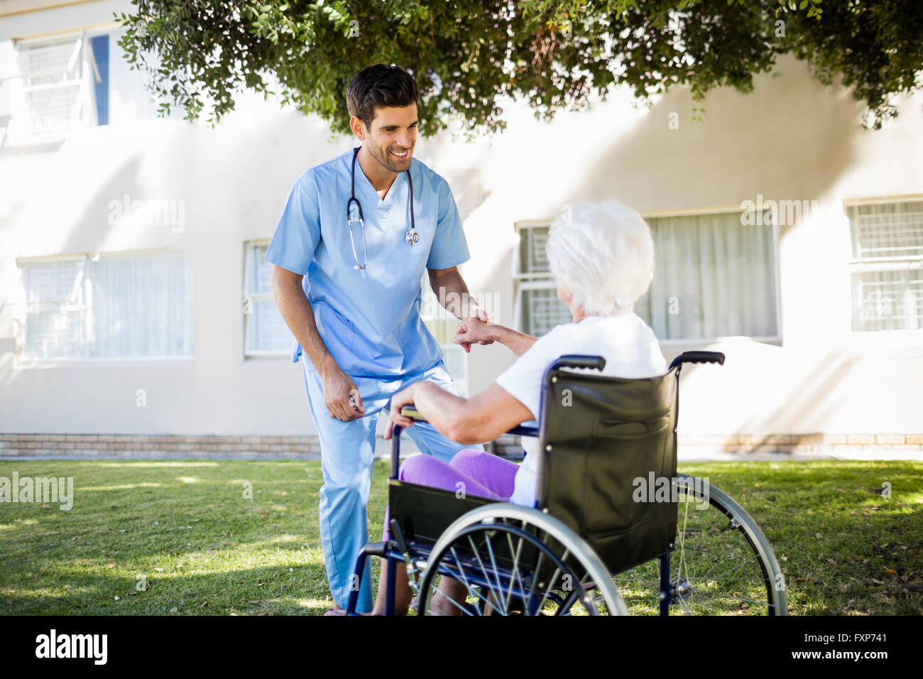Nurse helping senior woman to stand up Stock Photo - Alamy