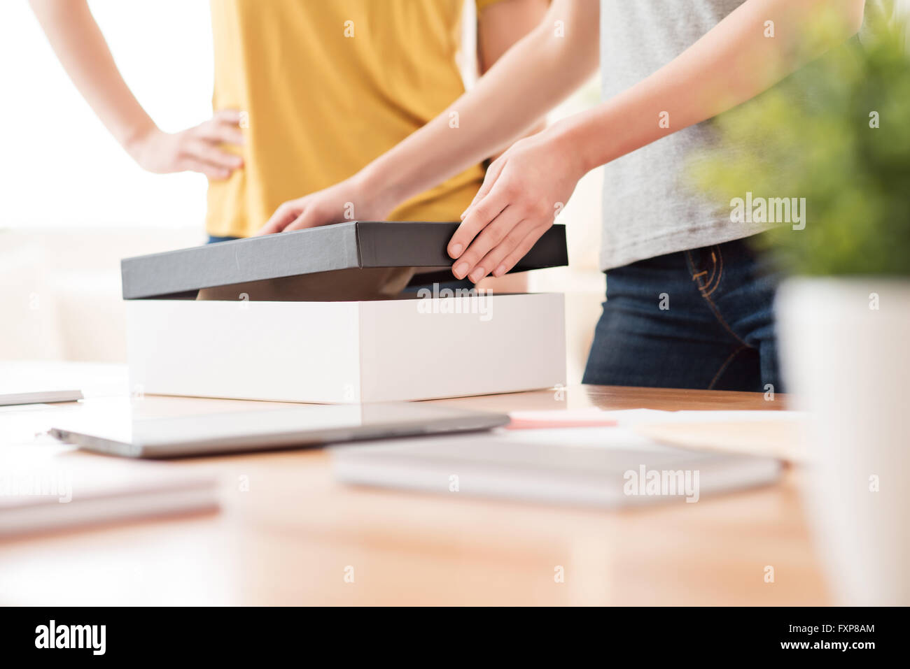 Pleasant girls packing the box Stock Photo - Alamy