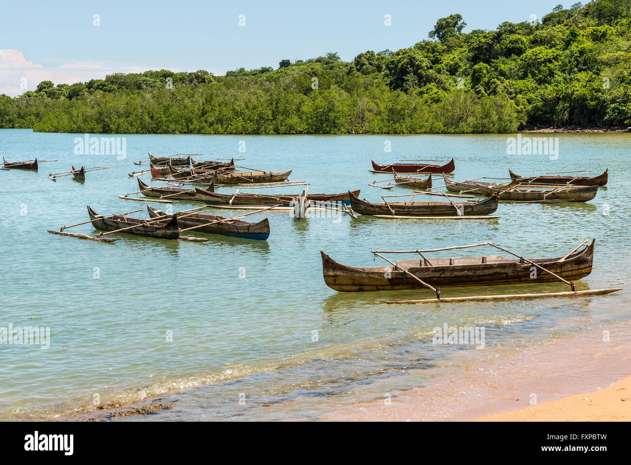 Traditional wooden dugout rowing outrigger canoes on Nosy Be island ...